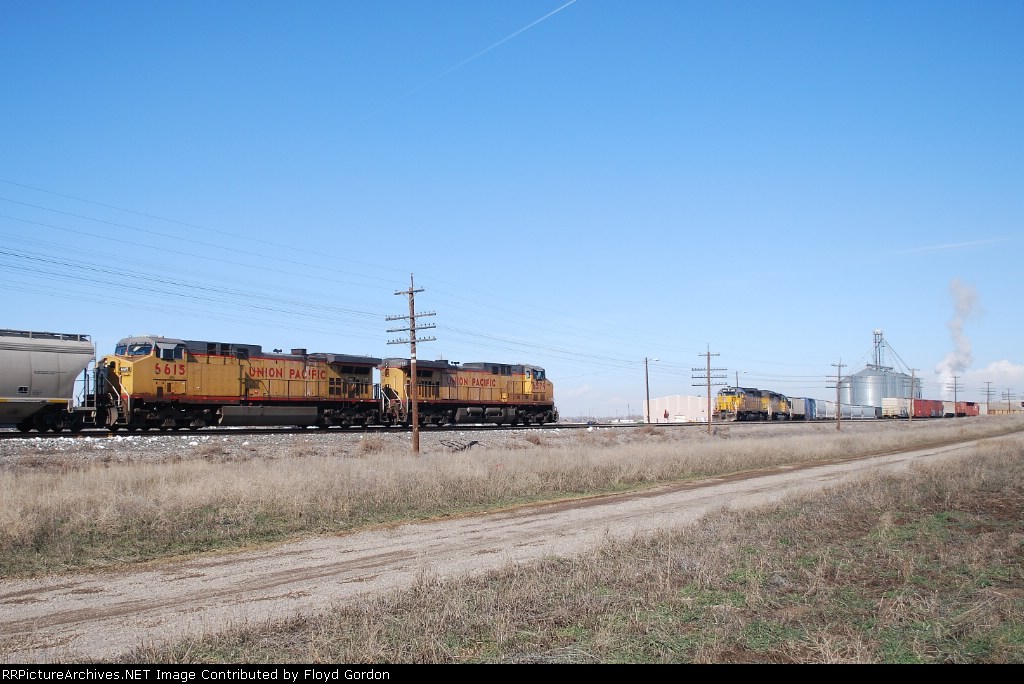 Westbound UP grain shuttle passes UP local 43